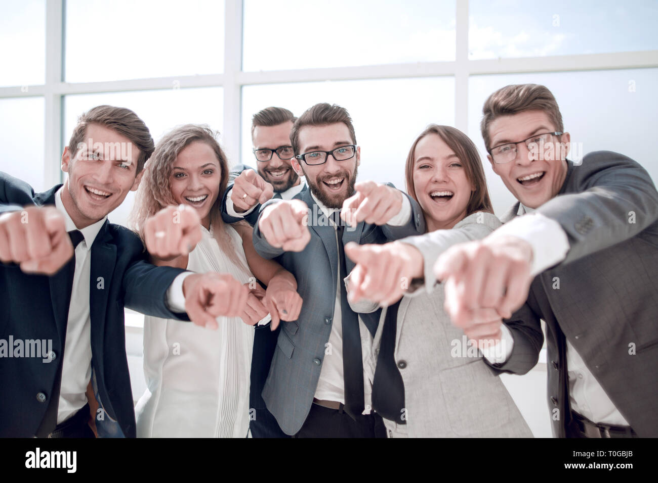 close up. successful business team pointing at you Stock Photo - Alamy