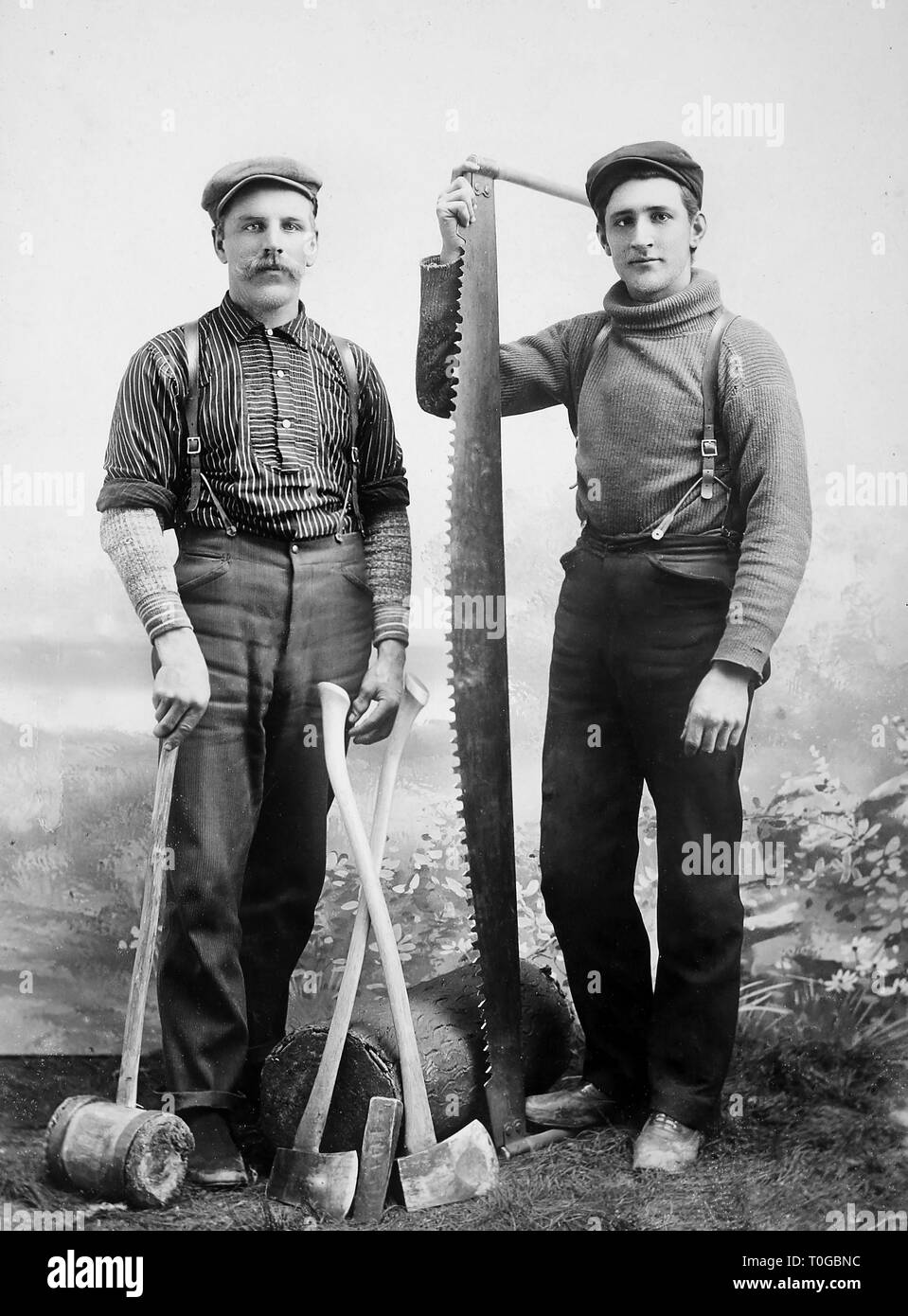 Two lumberjacks pose with the tools of their trade in Wisconsin, ca ...
