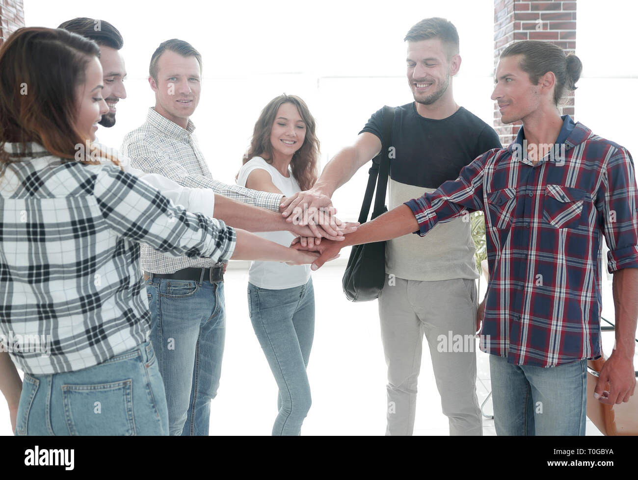 Business Team putting their hands together Stock Photo - Alamy