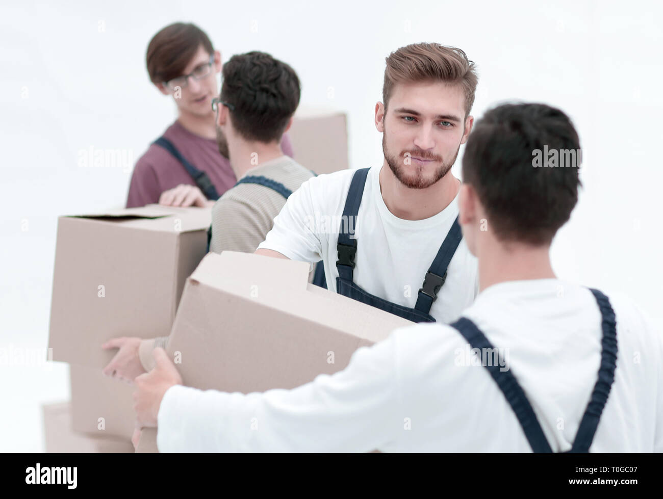 Delivery men with cardboard boxes on white background Stock Photo - Alamy