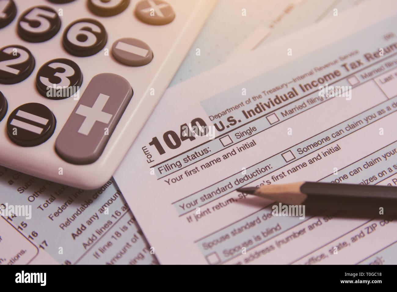 Tax season. calculator, pencil on 1040 tax form background Stock Photo ...
