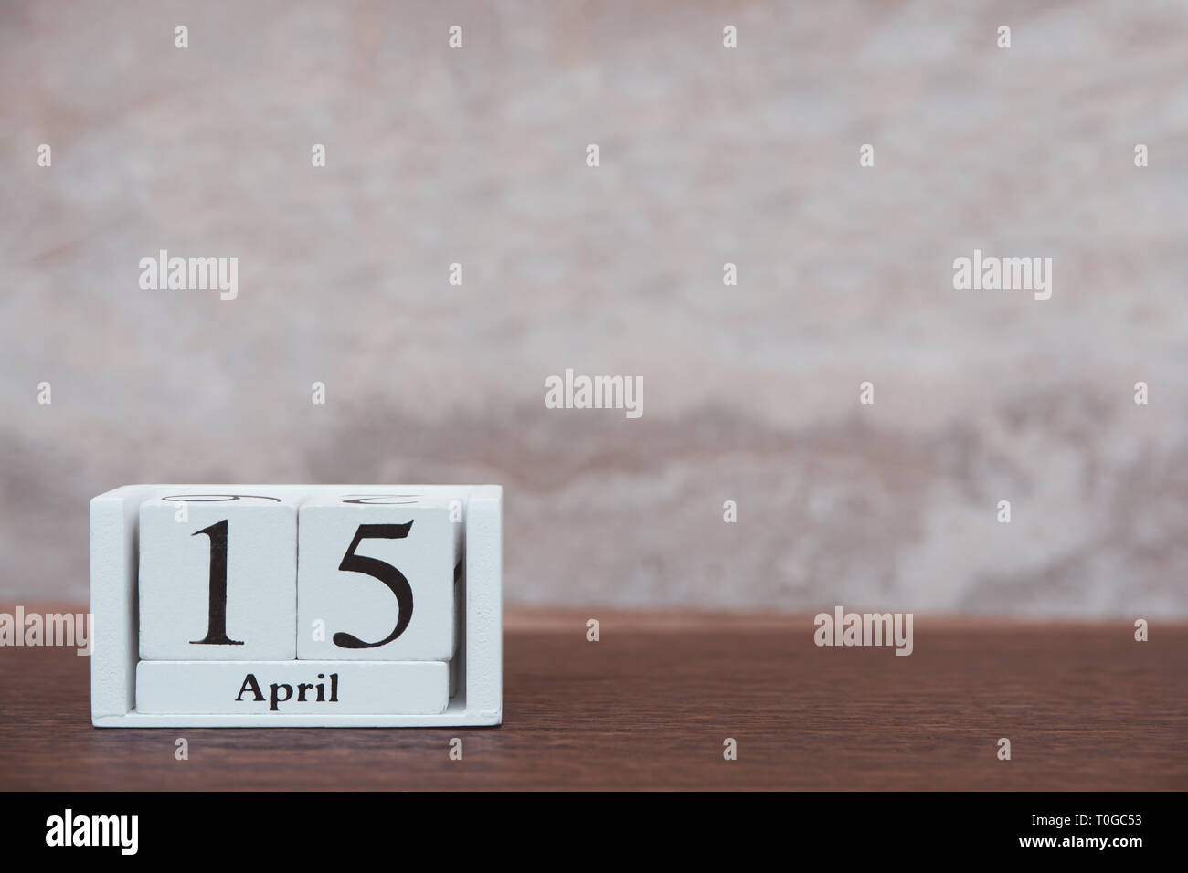 Tax day with 15th April. Calendar wooden block cube with number. On ...