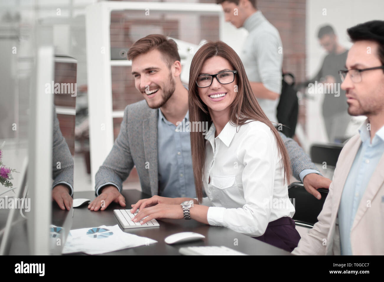group of business people sitting at the office table Stock Photo - Alamy