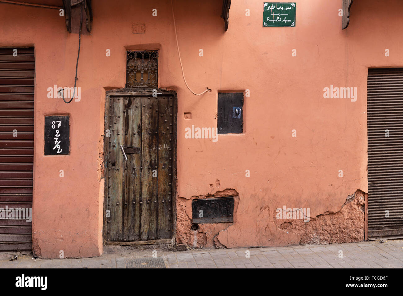 Beautiful old street of Marrakech with red buildings and old doors ...