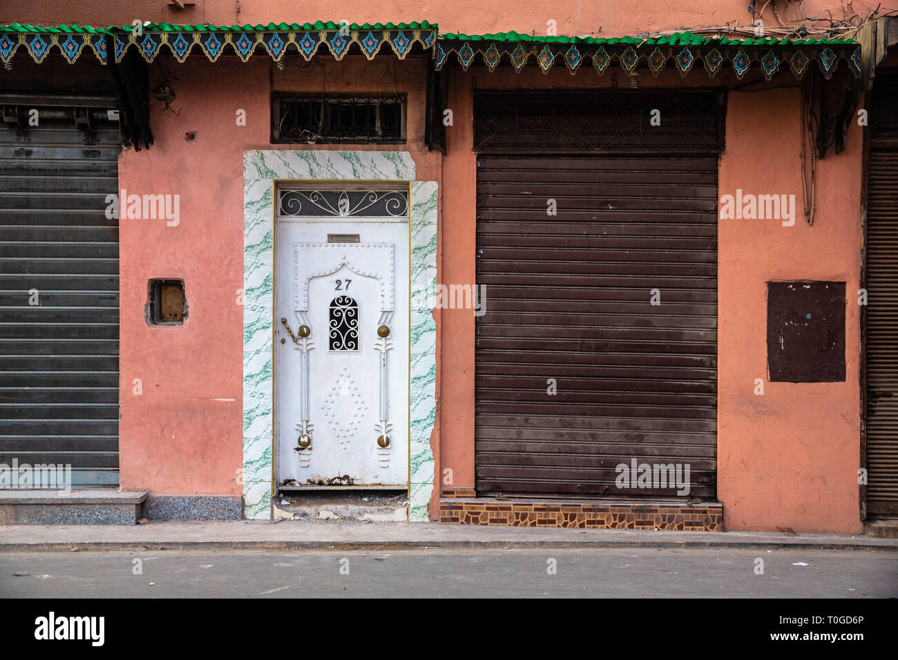Beautiful old street of Marrakech with red buildings and old doors ...