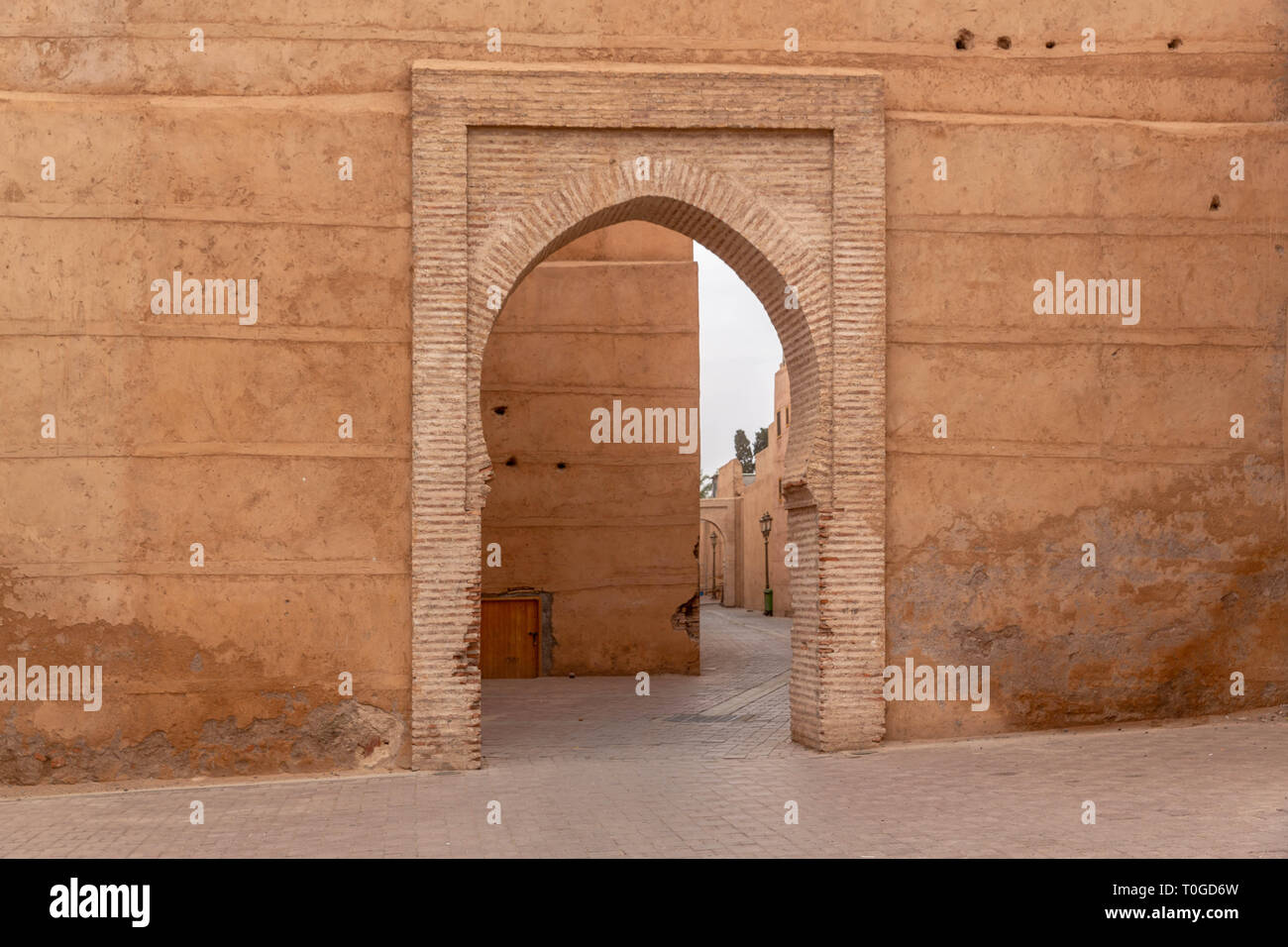 Beautiful old street of Marrakech with red buildings and old doors ...