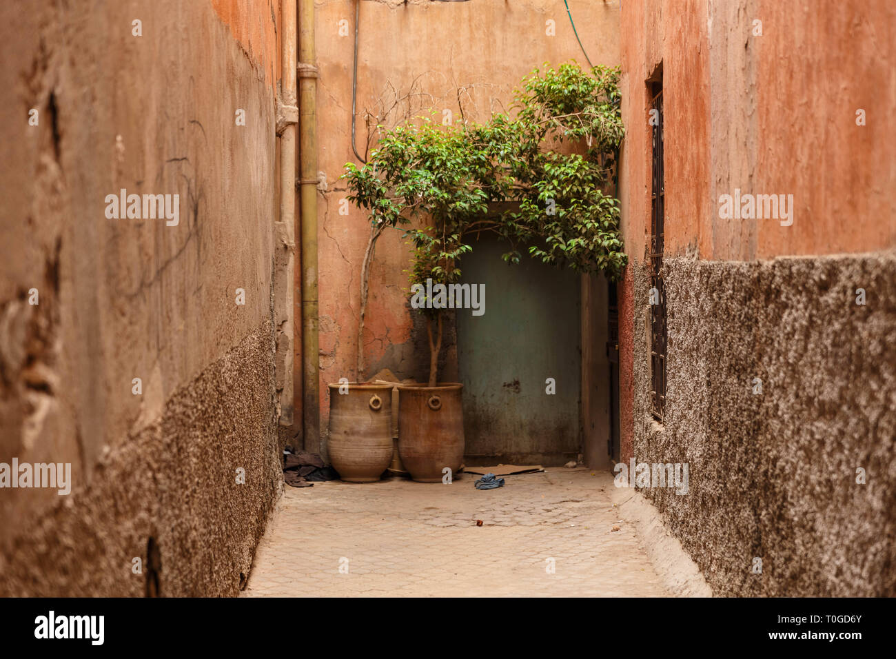 Beautiful old street of Marrakech with red buildings and old doors ...