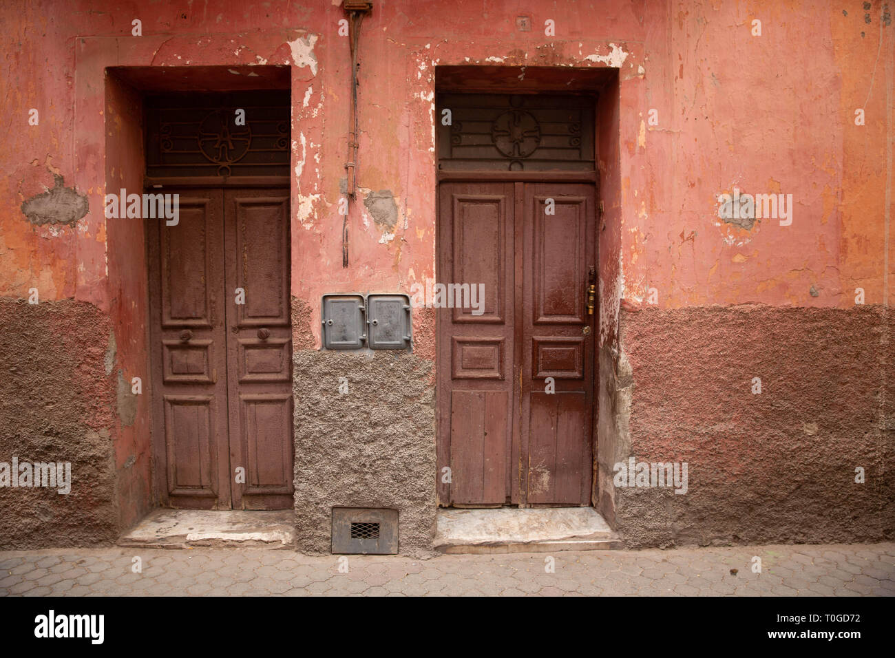 Beautiful old street of Marrakech with red buildings and old doors ...