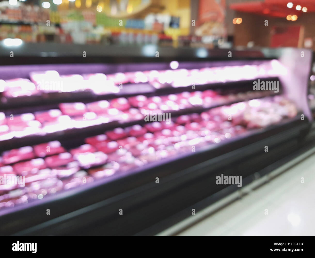 Supermarket shelf with meat blurred background. Red retail rack Stock ...