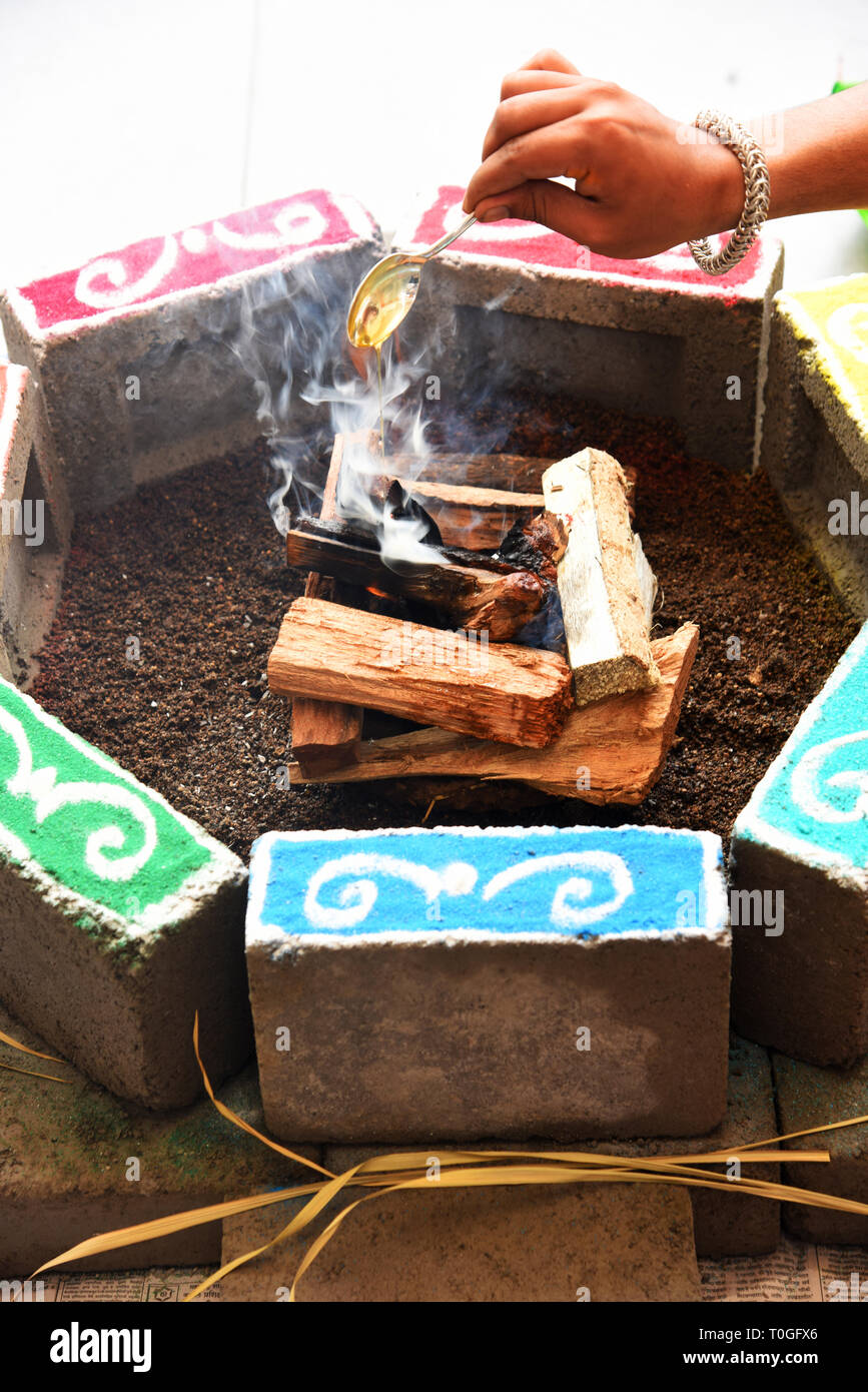 Priest performs home havan offerings to the fire, home kund is ...