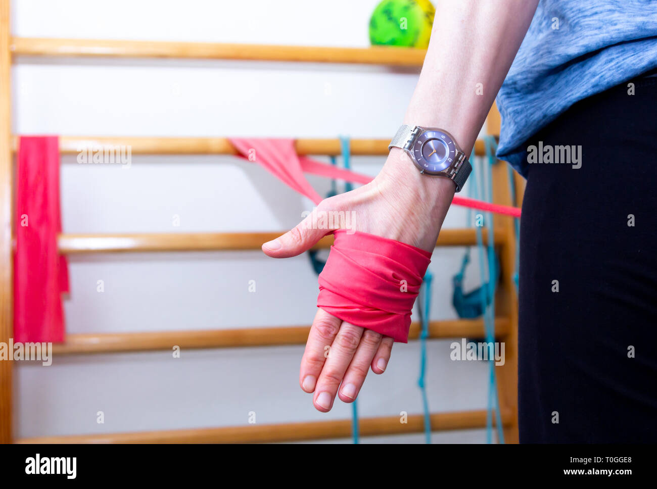 A woman is stretching with a stretch band Stock Photo - Alamy