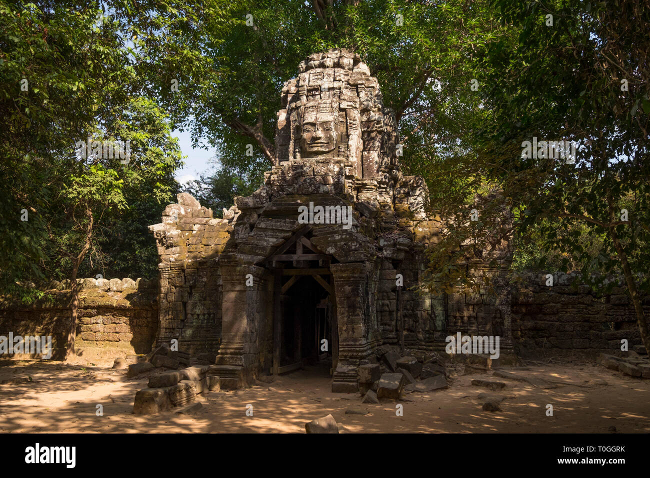 A Khmer gate featuring the iconic Avalokiteśvara head at Angkor in Siem ...