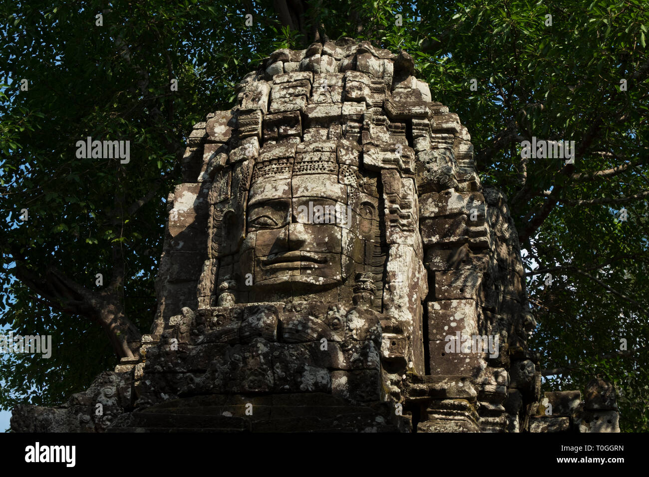 A Khmer gate top, featuring the iconic Avalokiteśvara head at Angkor in ...