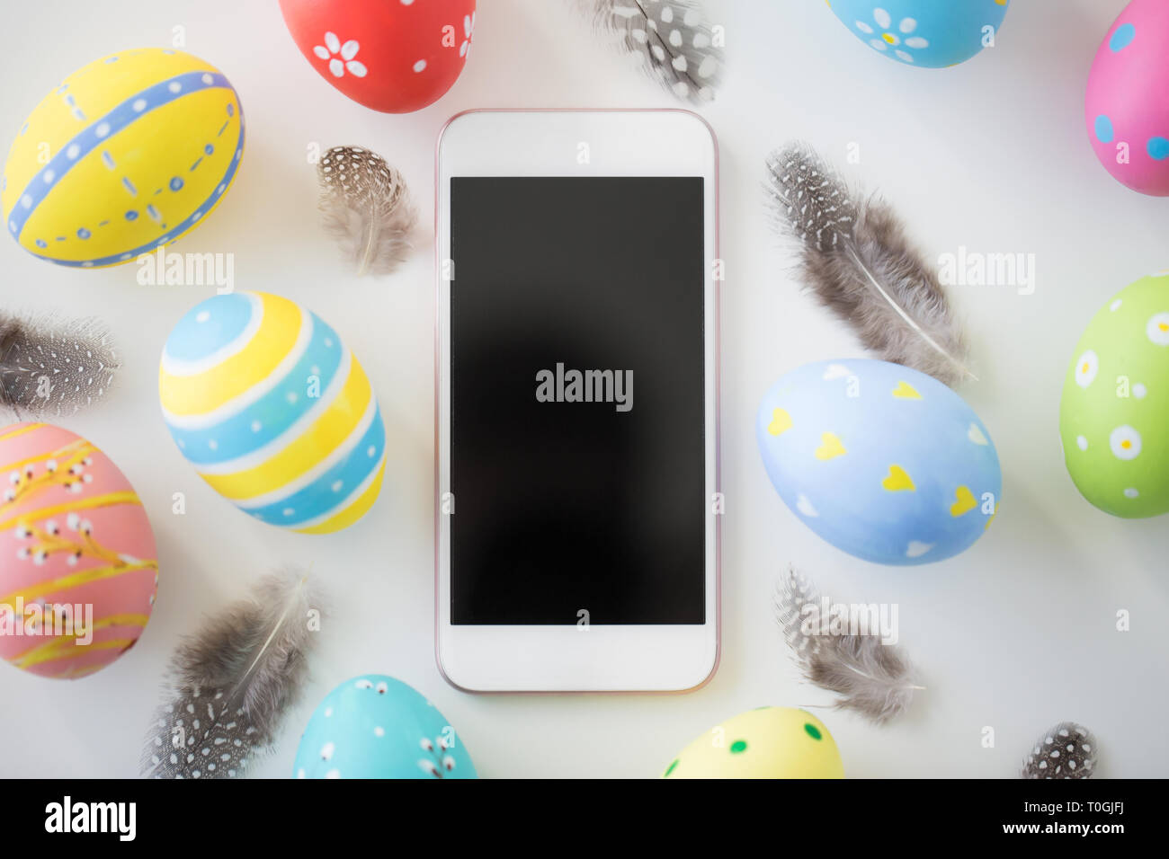 smartphone with easter eggs and feathers Stock Photo - Alamy