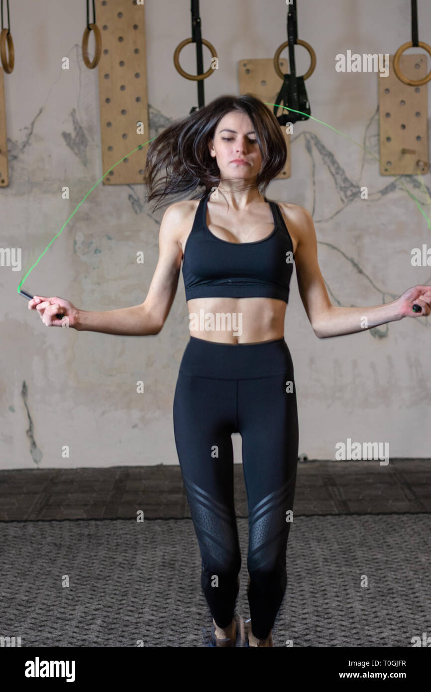 Girl jumping rope in the gym Stock Photo - Alamy