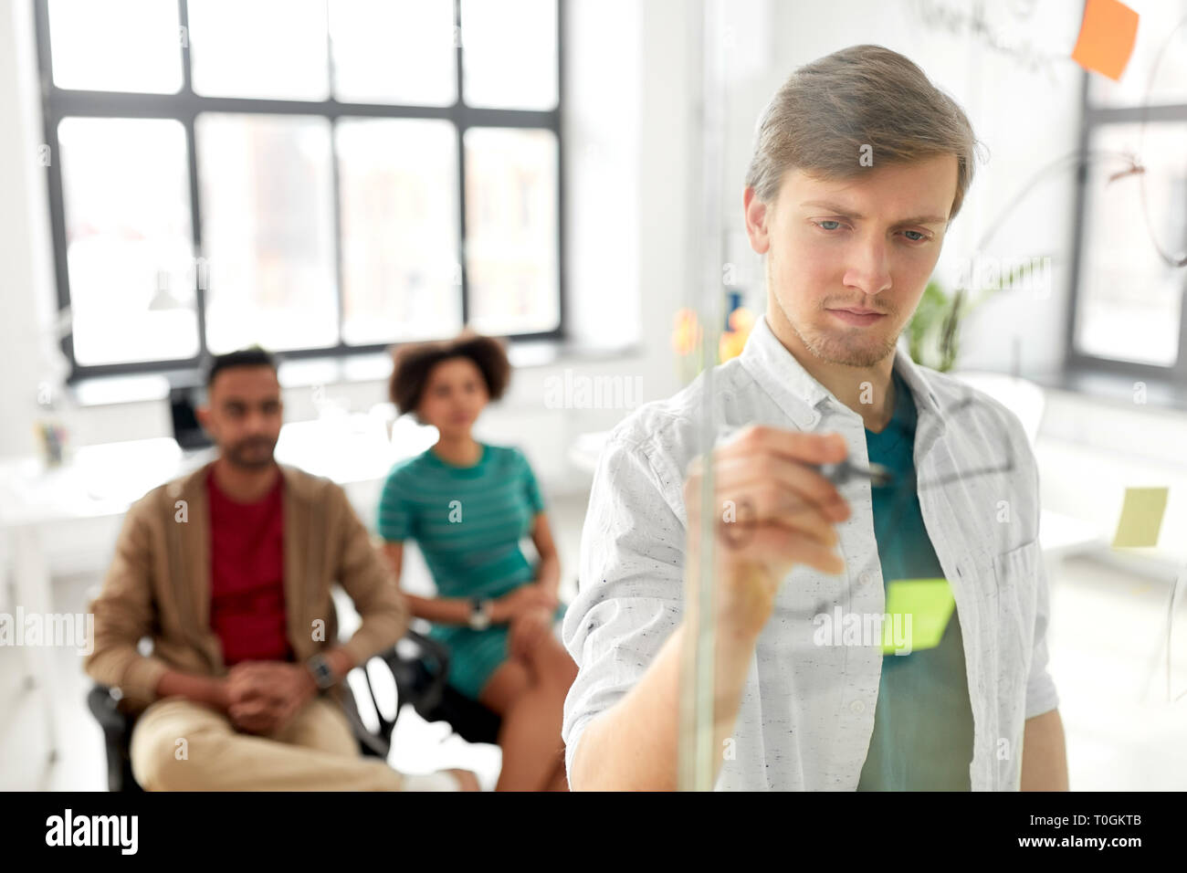 creative team with scheme on office glass board Stock Photo - Alamy