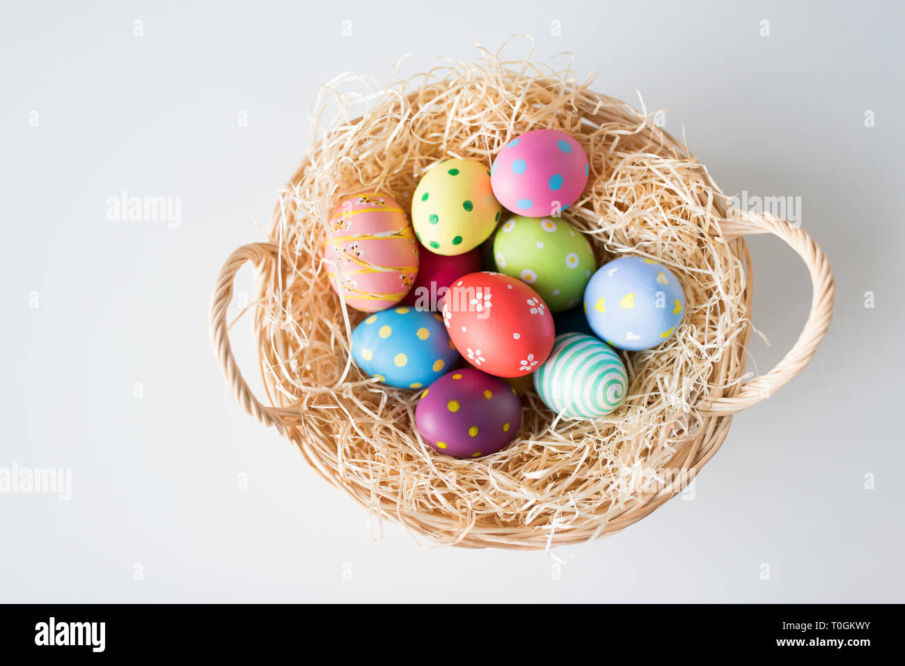 colored easter eggs in basket Stock Photo - Alamy