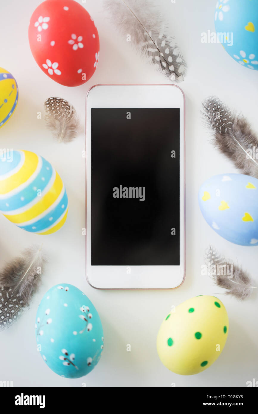 smartphone with easter eggs and feathers Stock Photo - Alamy