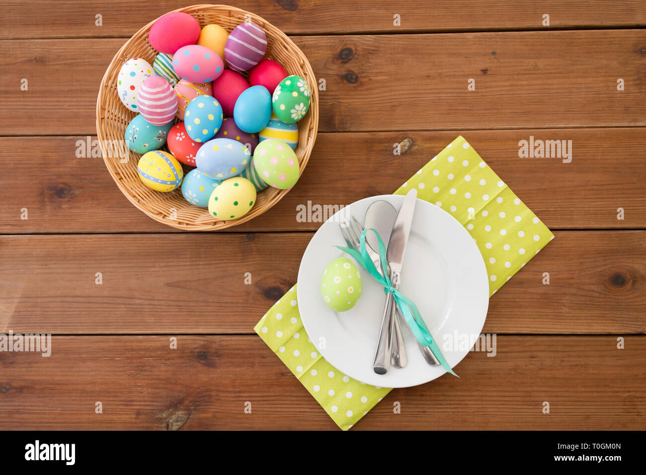easter eggs in basket, plates, cutlery and flowers Stock Photo - Alamy