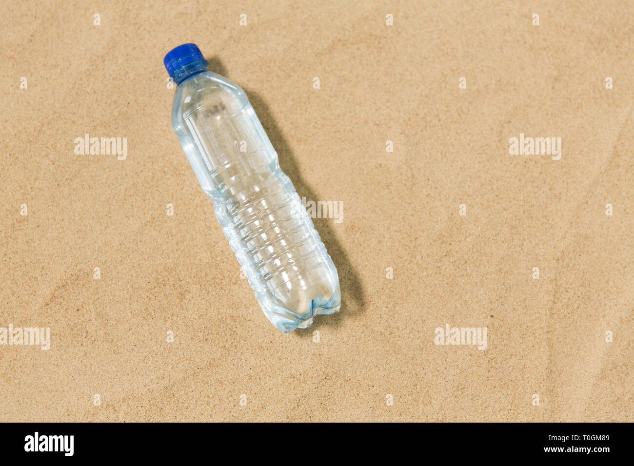 bottle of water on beach sand Stock Photo - Alamy