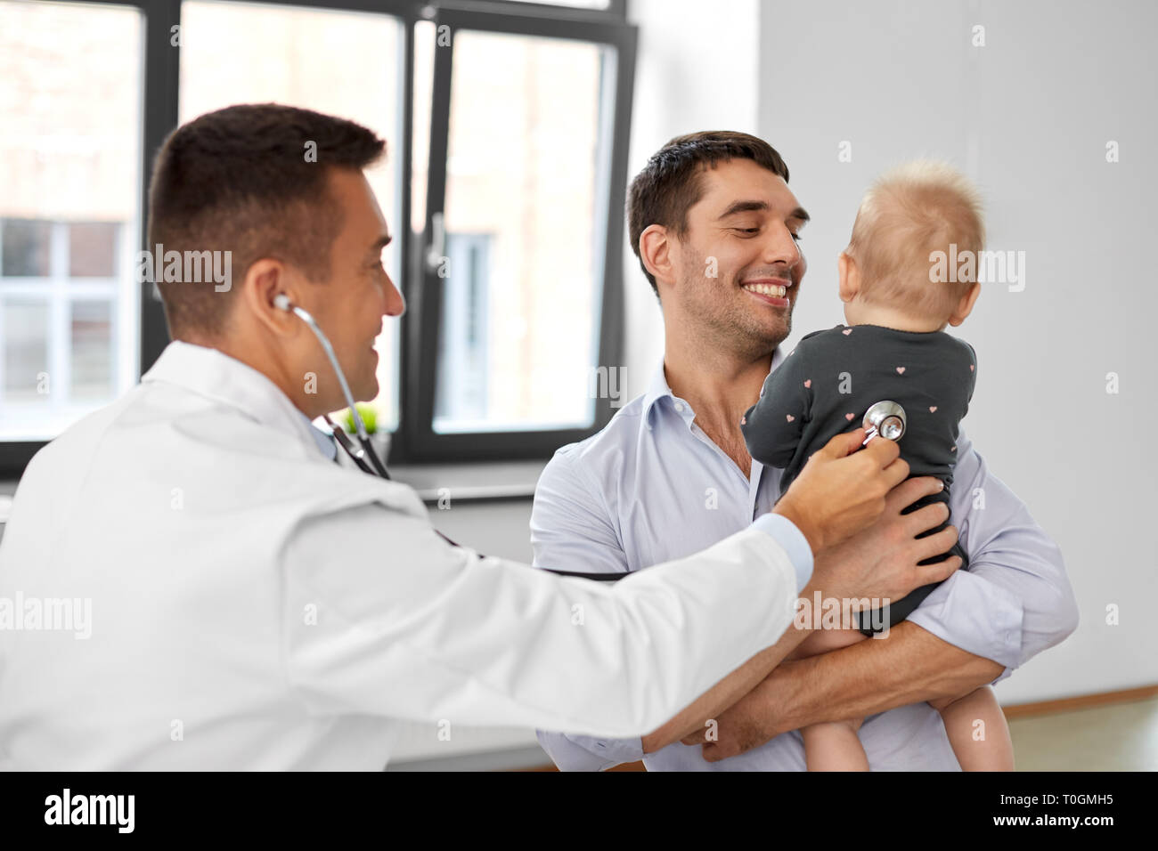 father with baby and doctor at clinic Stock Photo - Alamy