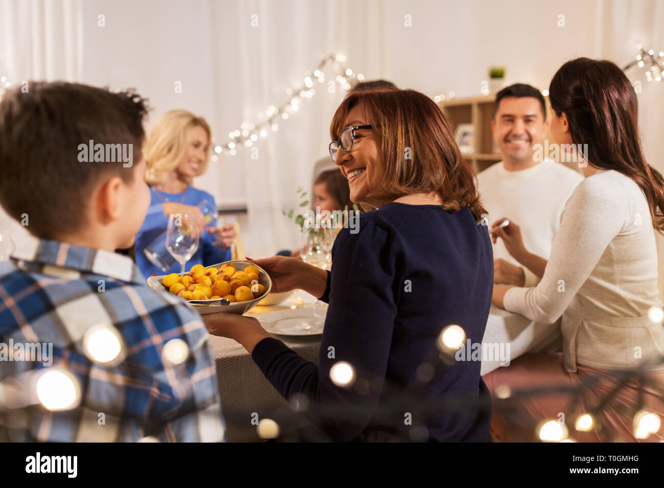 happy family having dinner party at home Stock Photo - Alamy