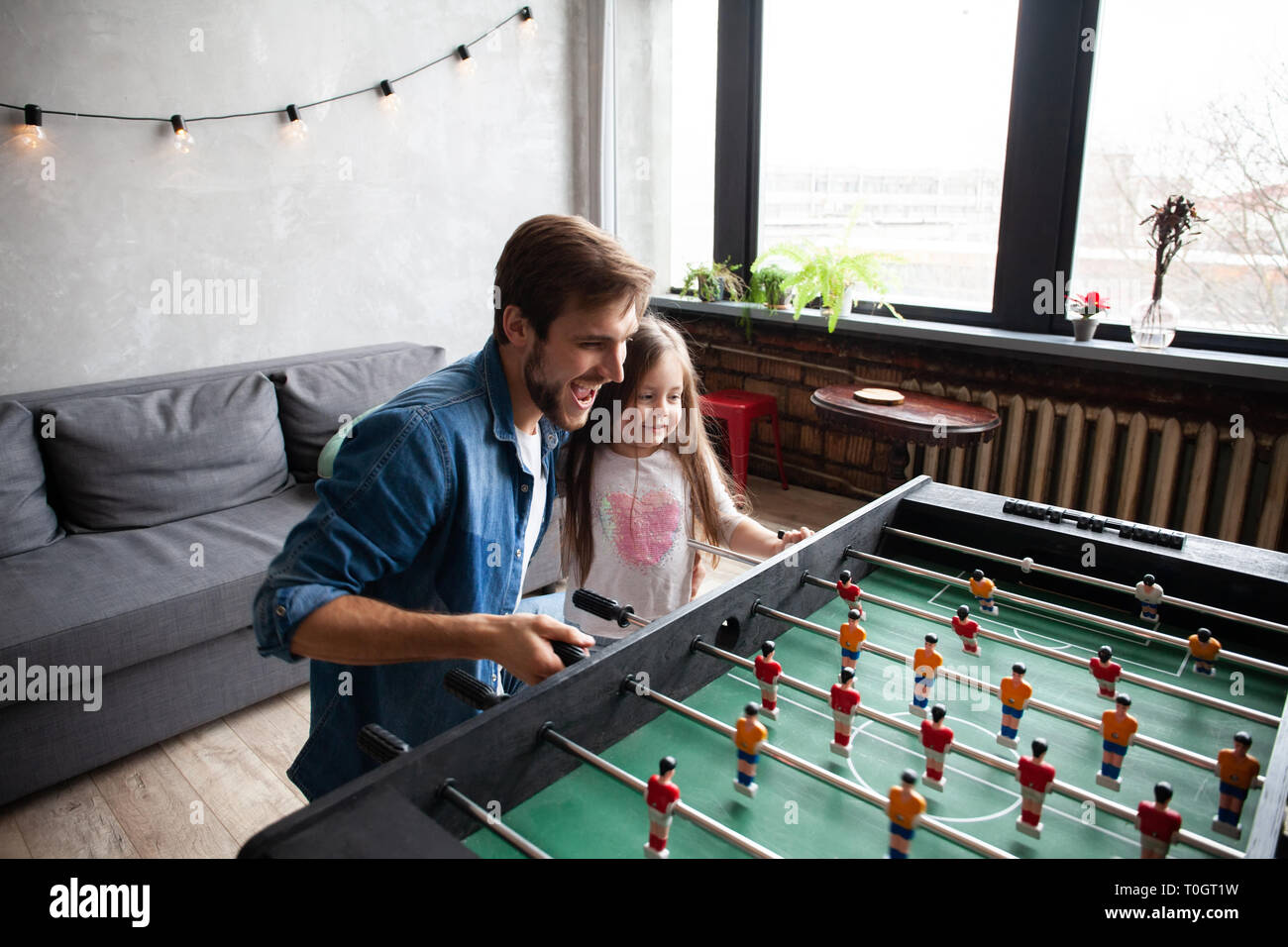 Family holiday and togetherness. Father and daughter playing table ...