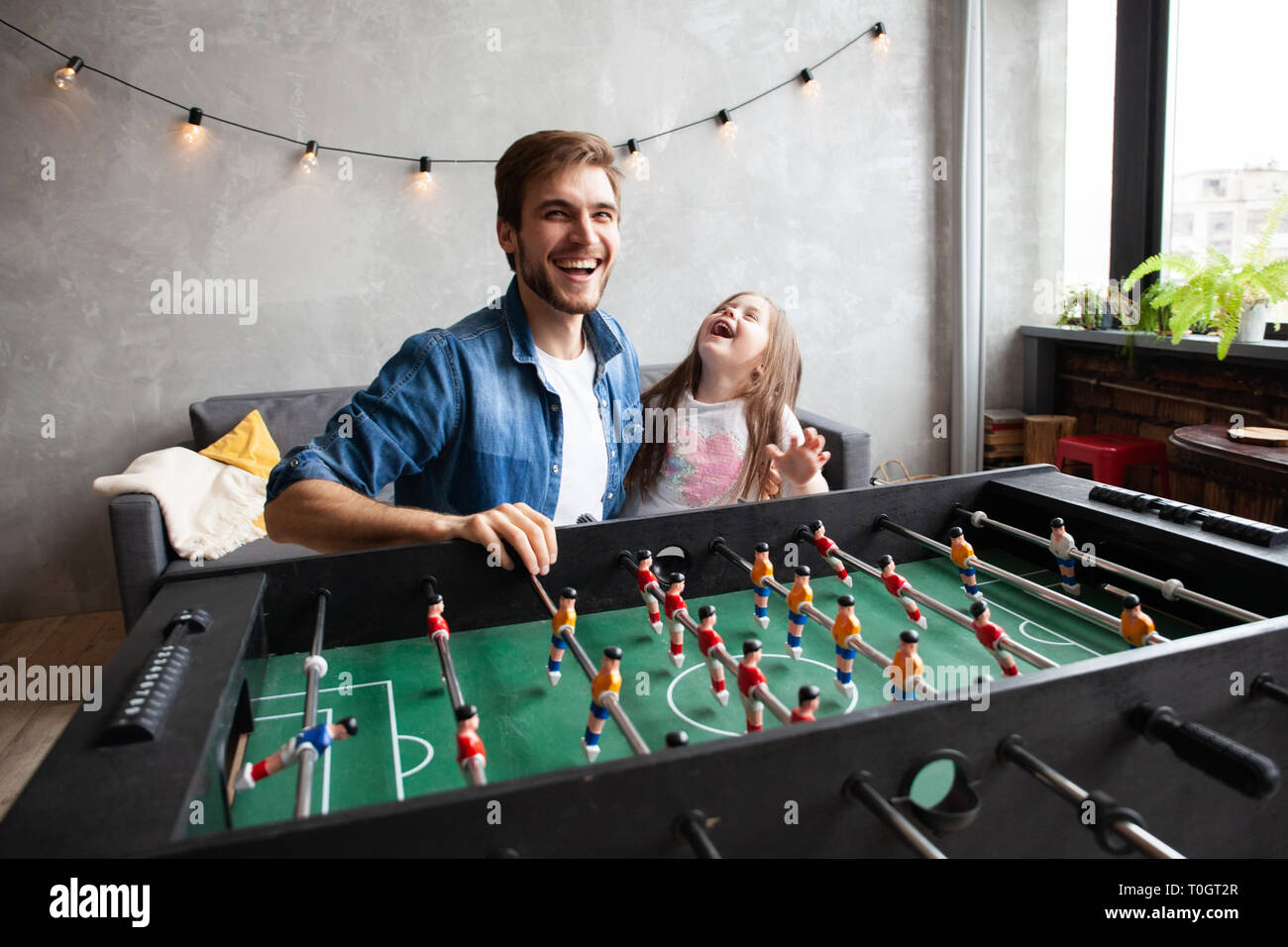 Family holiday and togetherness. Father and daughter playing table ...