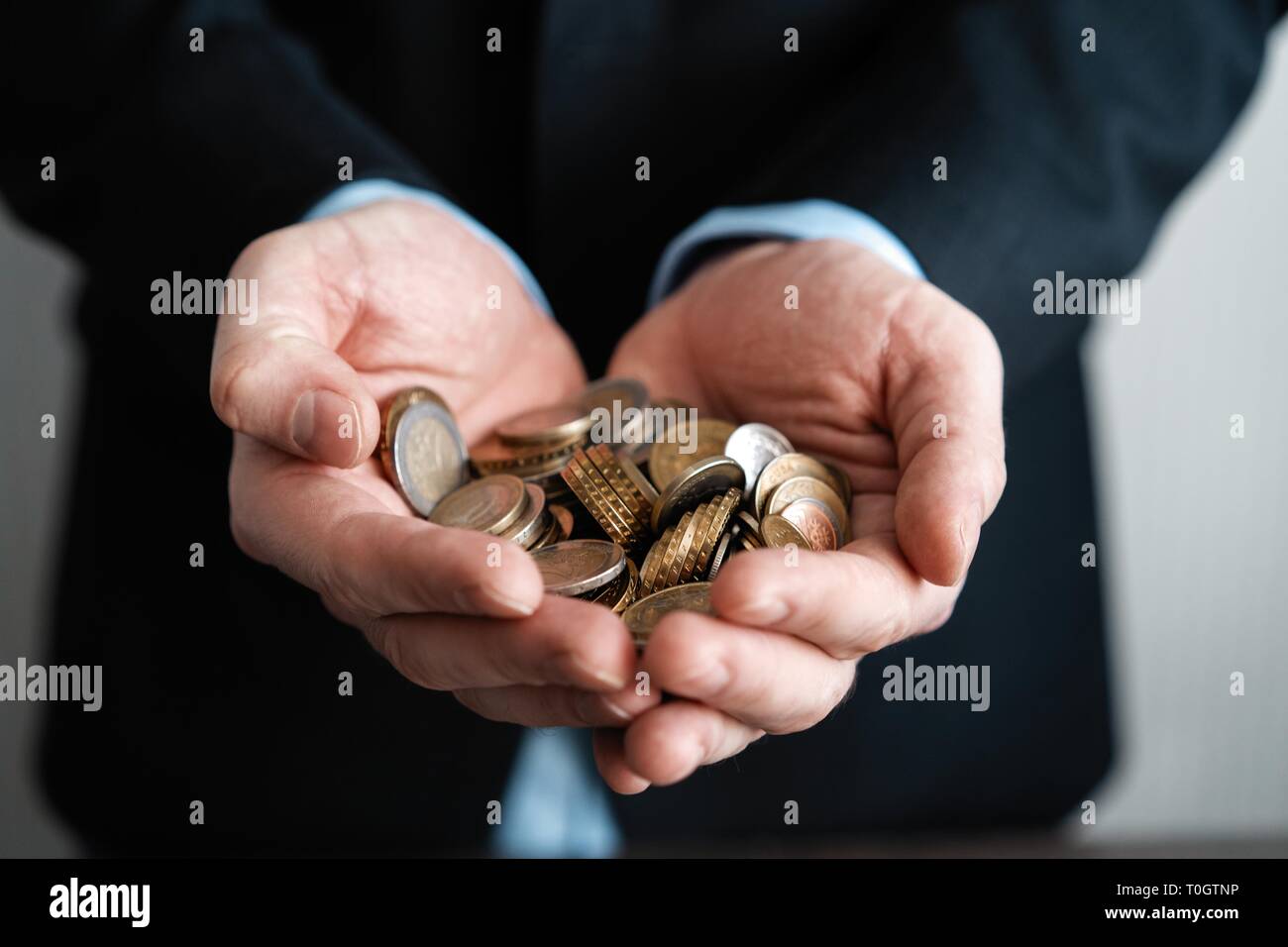 coins in hands. saving money concept. Money growing Stock Photo - Alamy