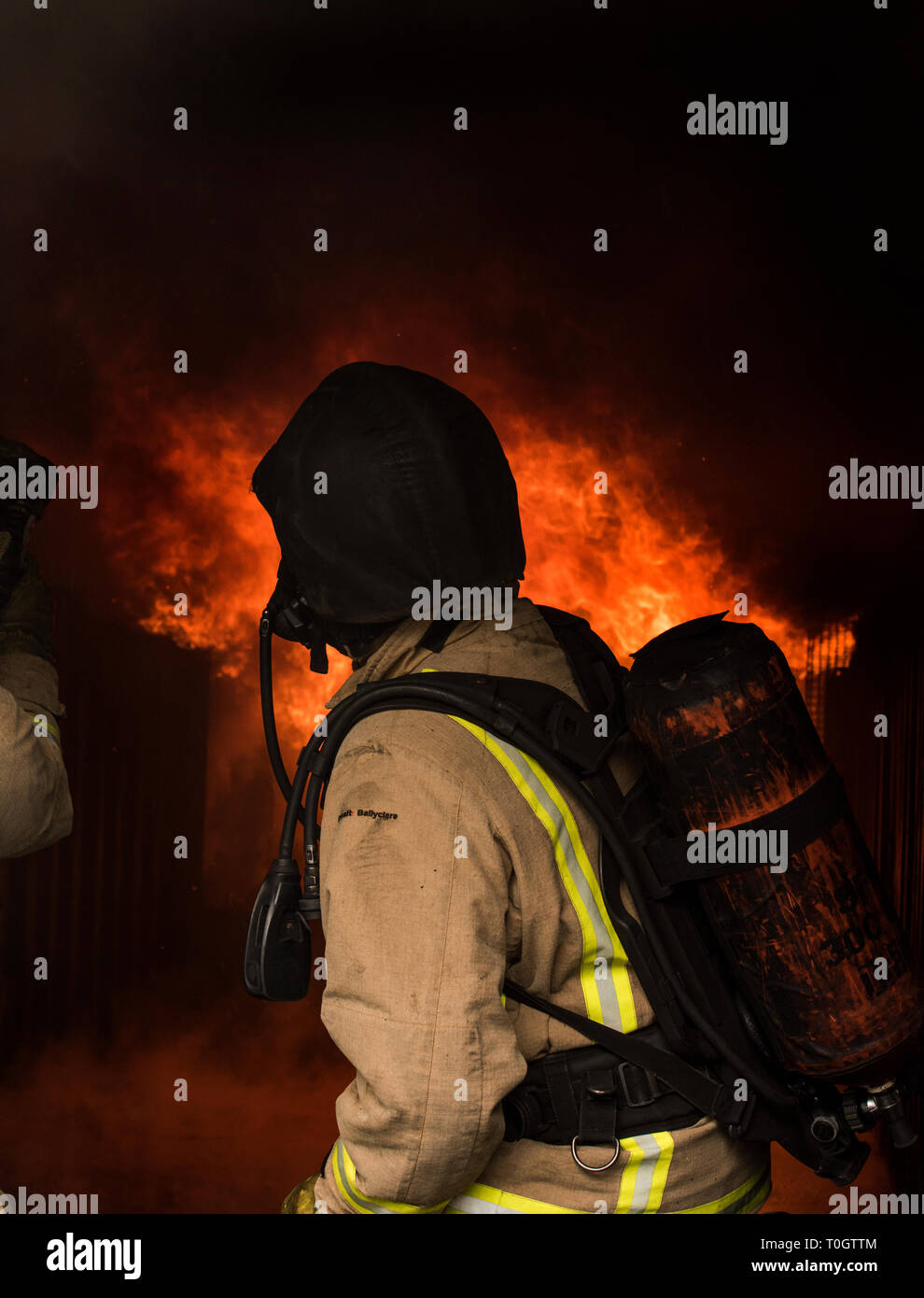 UK Fire fighter in building on fire Stock Photo - Alamy