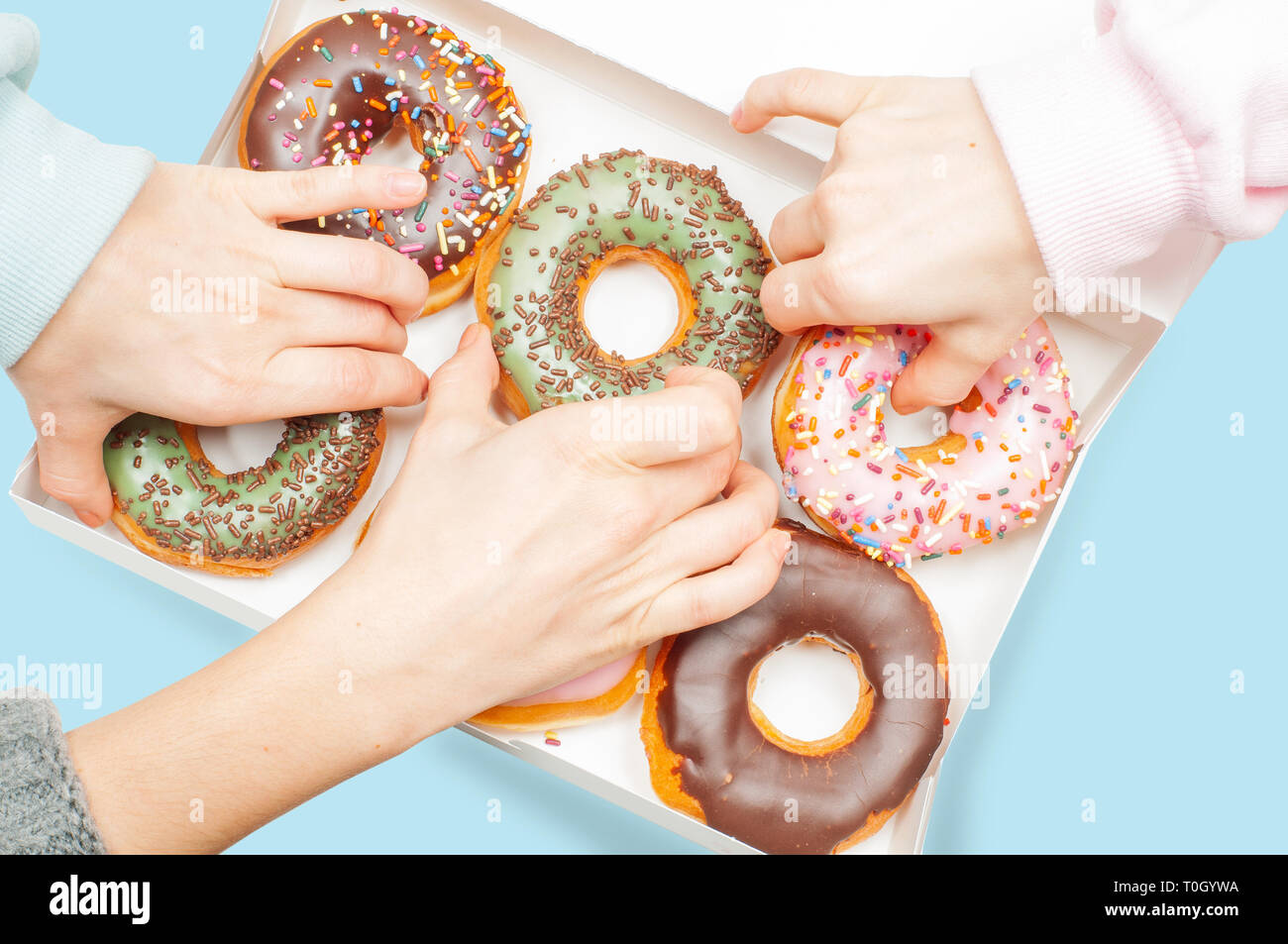 Woman grabbing donut hi-res stock photography and images - Alamy