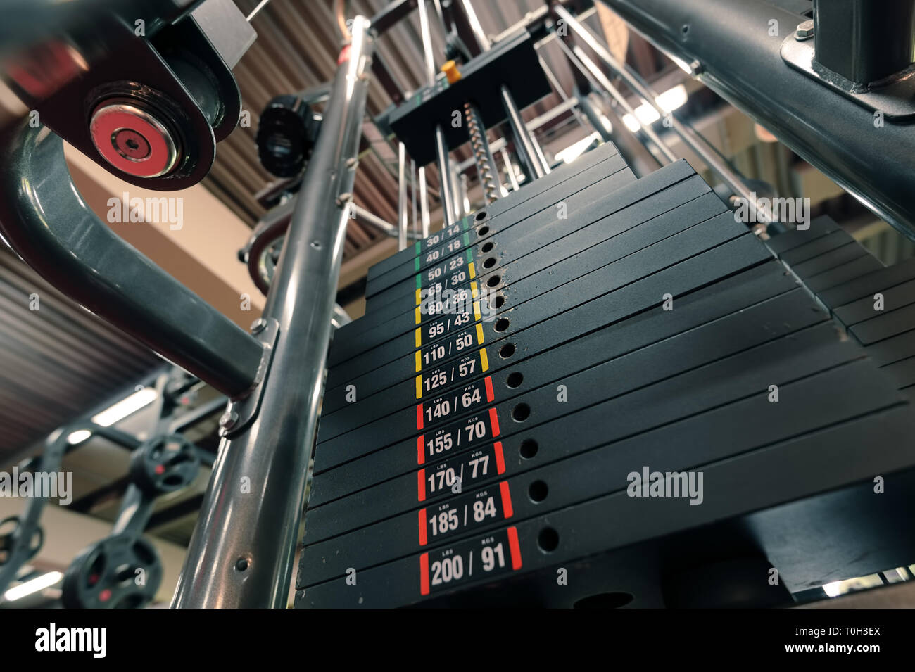 Weights in gym machine Stock Photo - Alamy