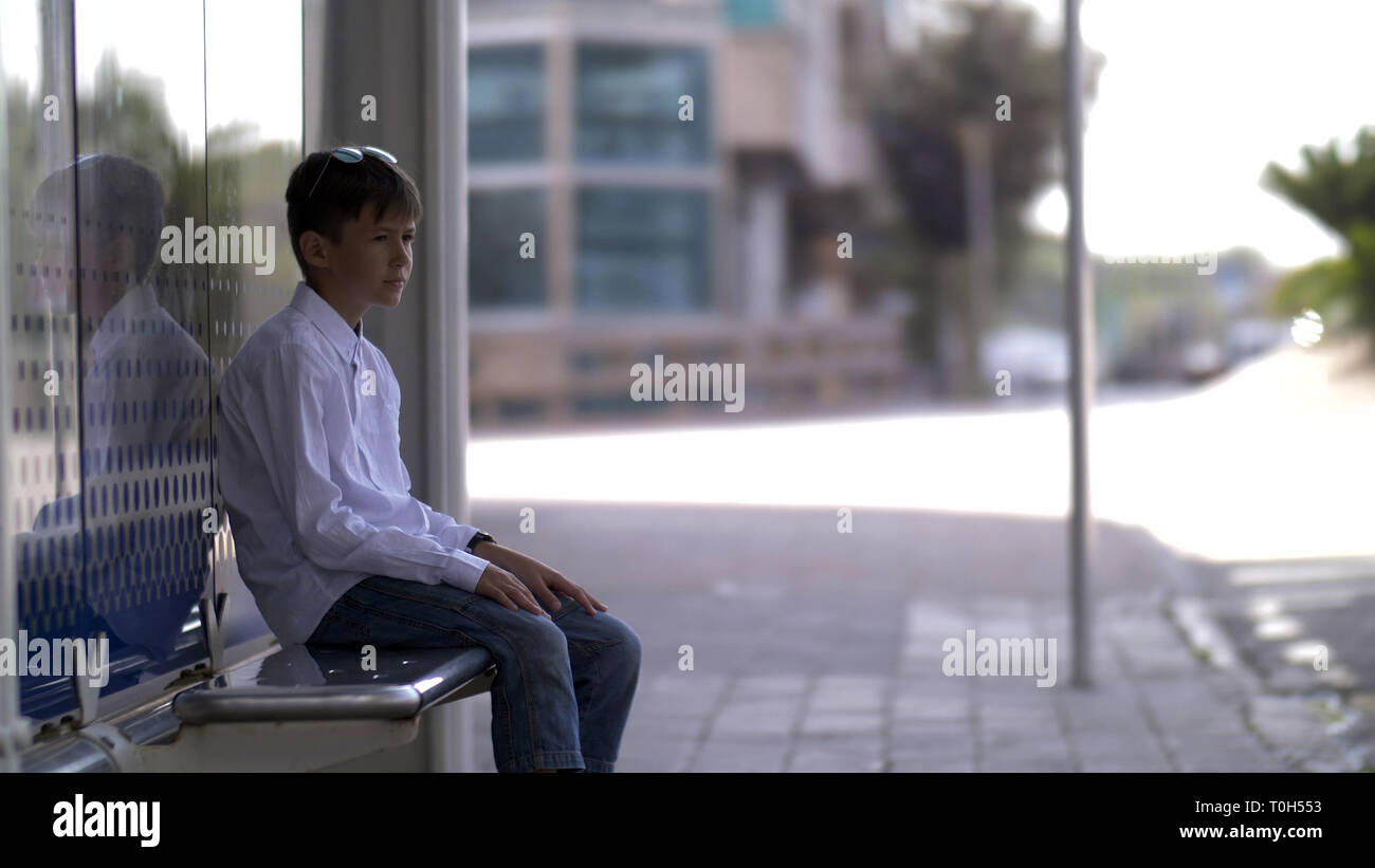 Sitting bus stop sad hi-res stock photography and images - Alamy