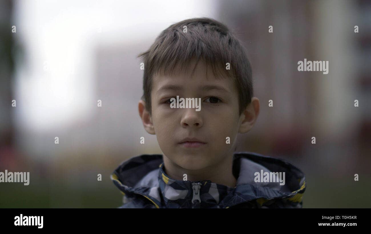 beaten tired serious boy looks at the camera Stock Photo - Alamy