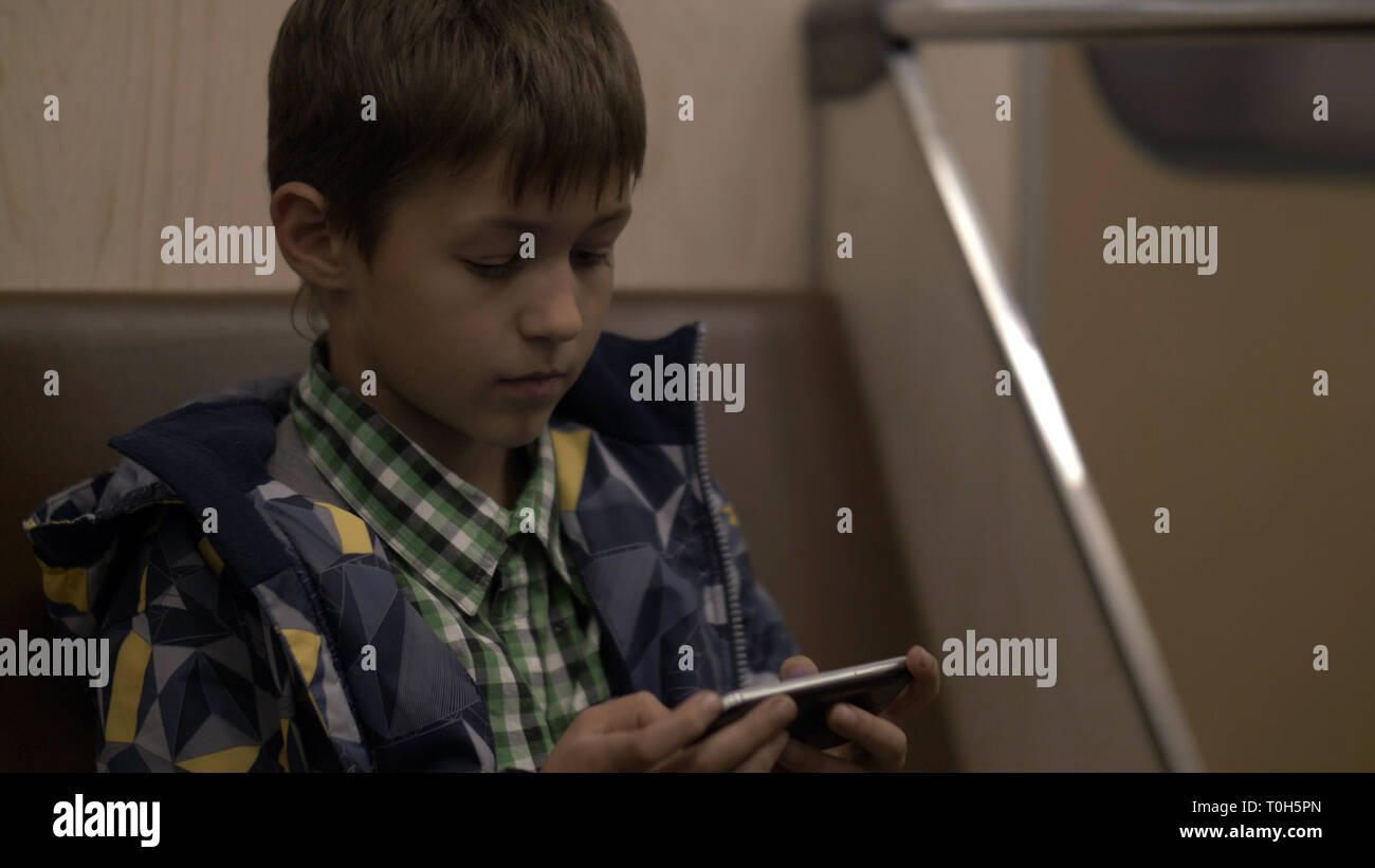 boy rides on the subway and use the phone Stock Photo - Alamy