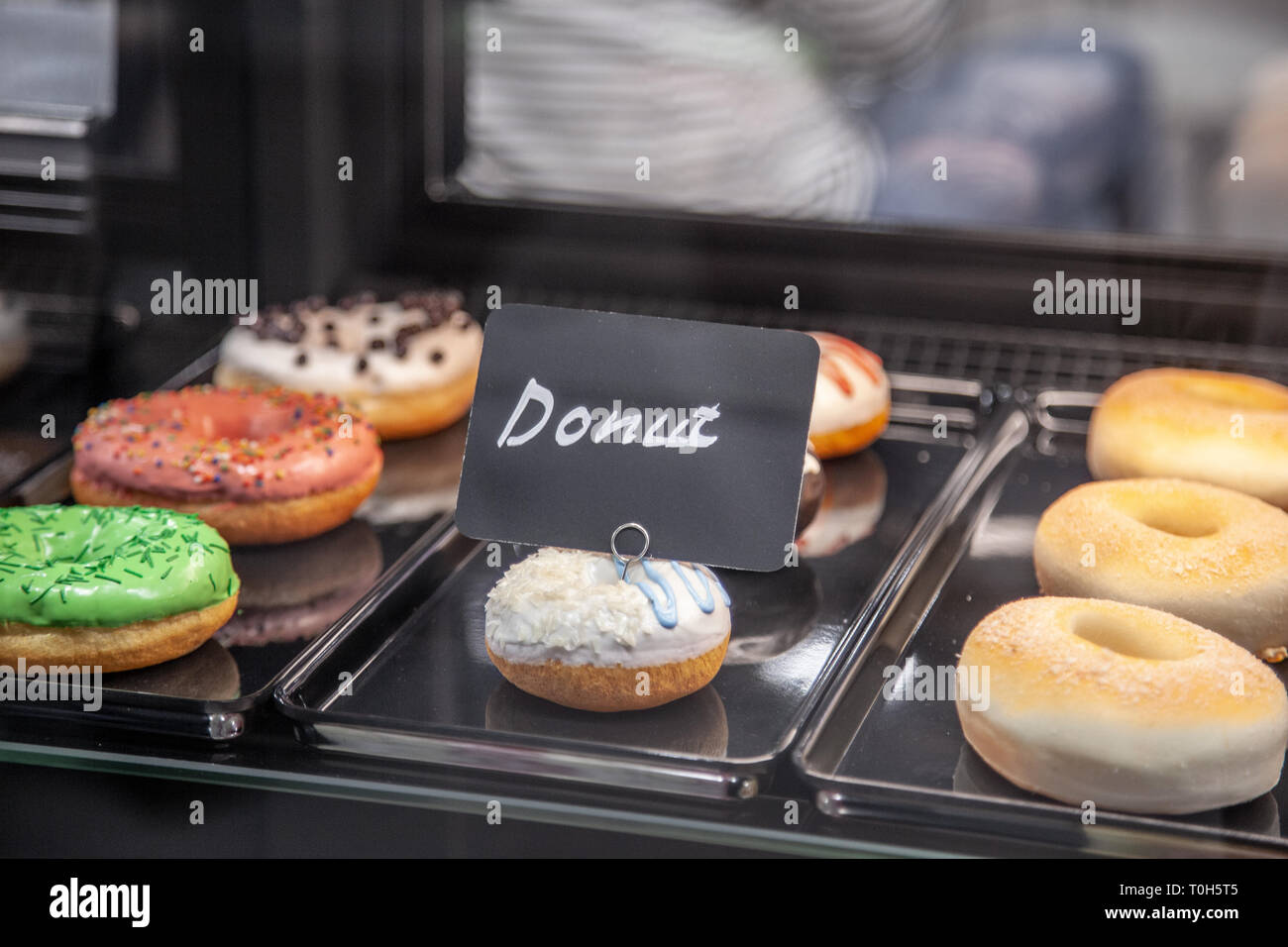 Multicolored donuts in shop window Stock Photo - Alamy