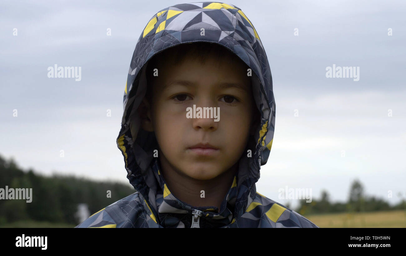 serious offended young boy looking at the camera, pain on face Stock ...