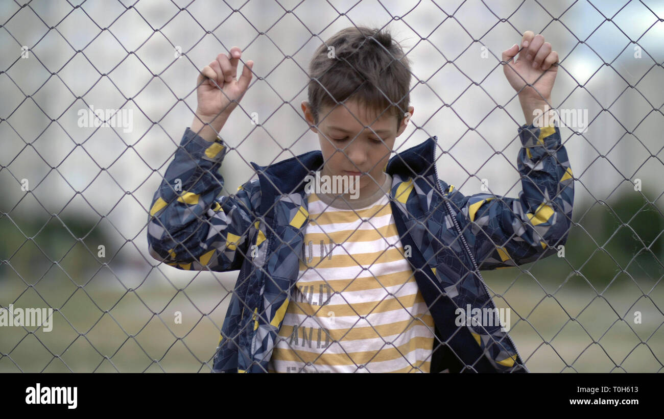 lonely boy, regret for action, pain on face, refugee Stock Photo - Alamy