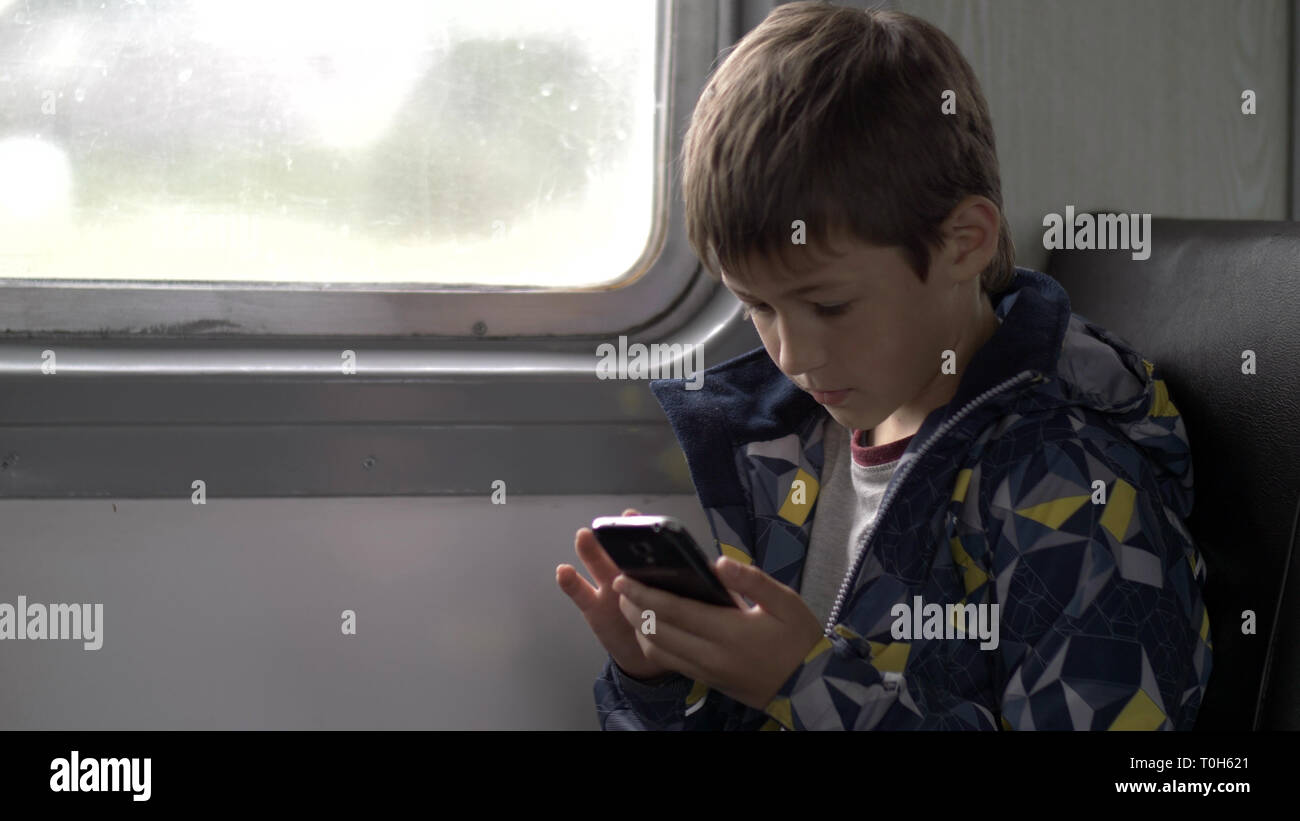 Boy smartphone bus hi-res stock photography and images - Alamy