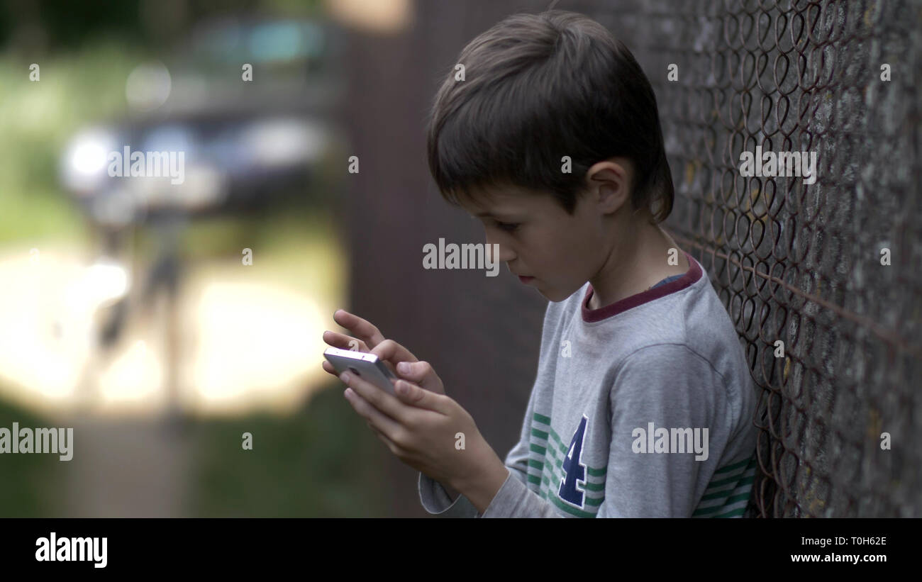 Boy using phone in nature hi-res stock photography and images - Alamy