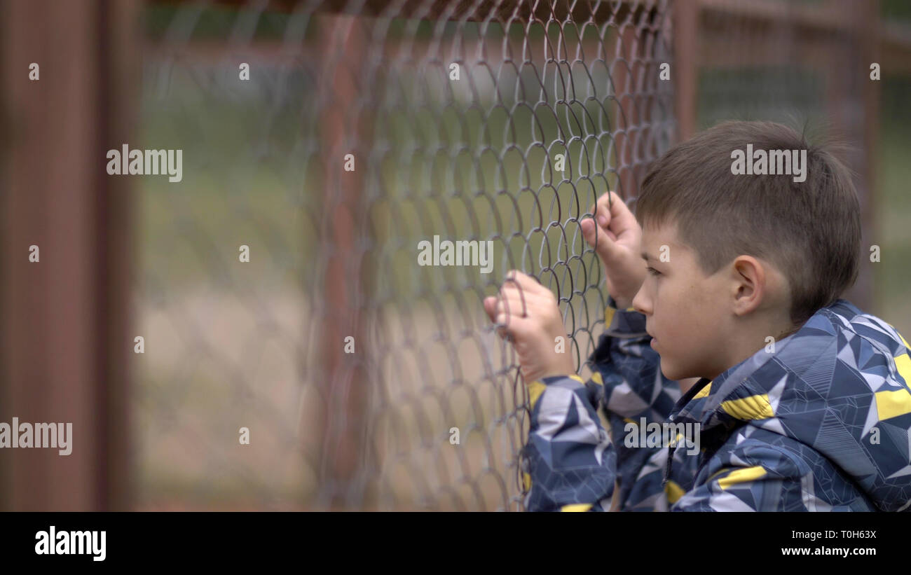 lonely boy lowers head, regret for action, pain on face Stock Photo - Alamy