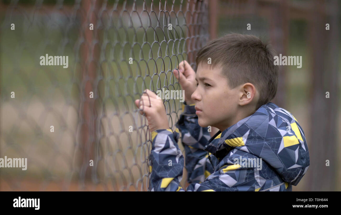 lonely boy lowers head, regret for action, pain on face Stock Photo - Alamy