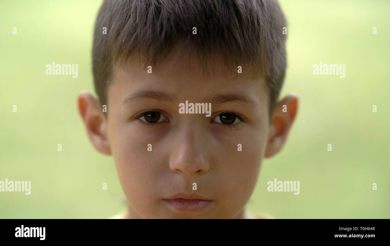 portrait of little sad desperate kid looking at camera, close up Stock ...