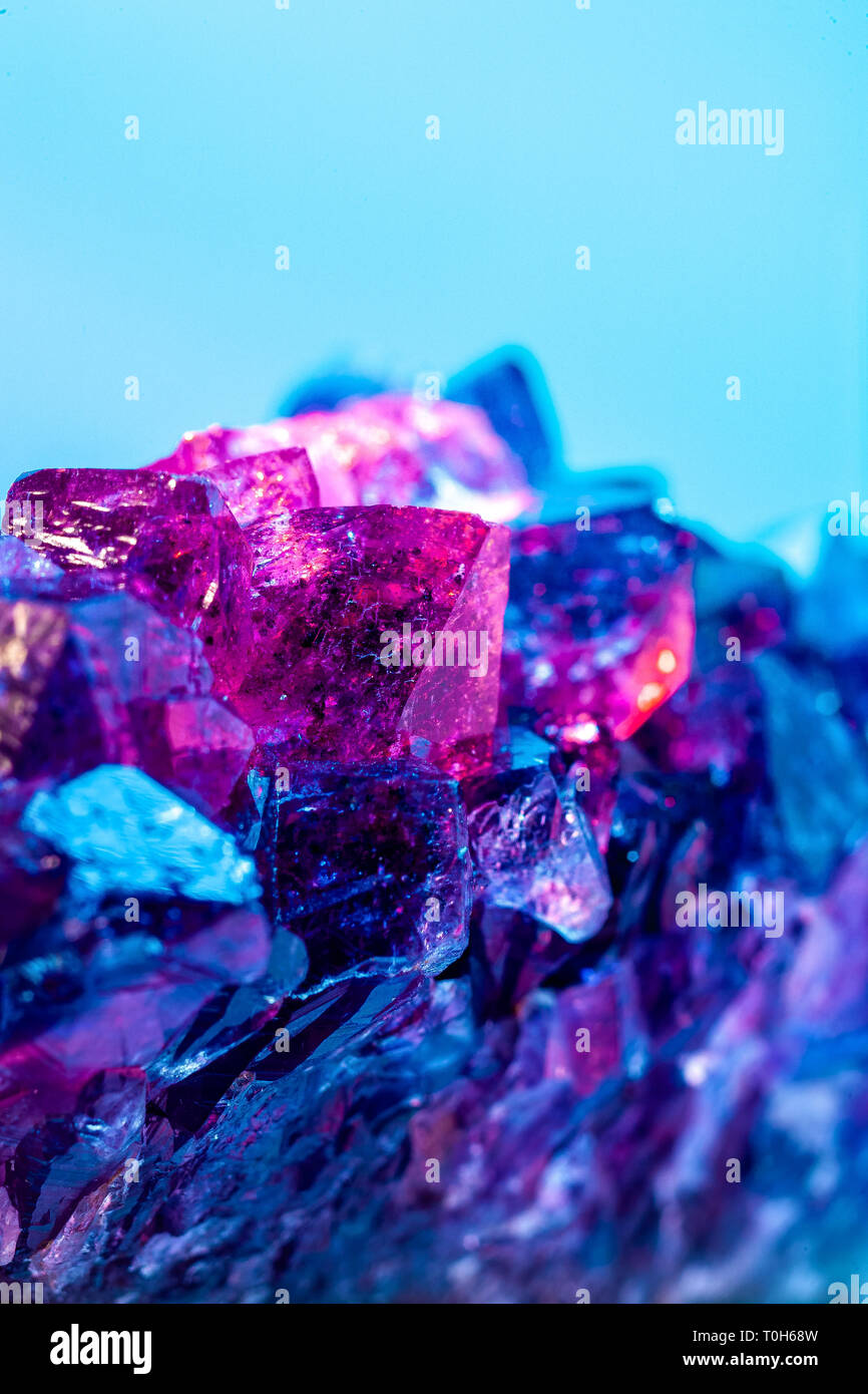 Amethyst stone against simple colour backgrounds Stock Photo - Alamy