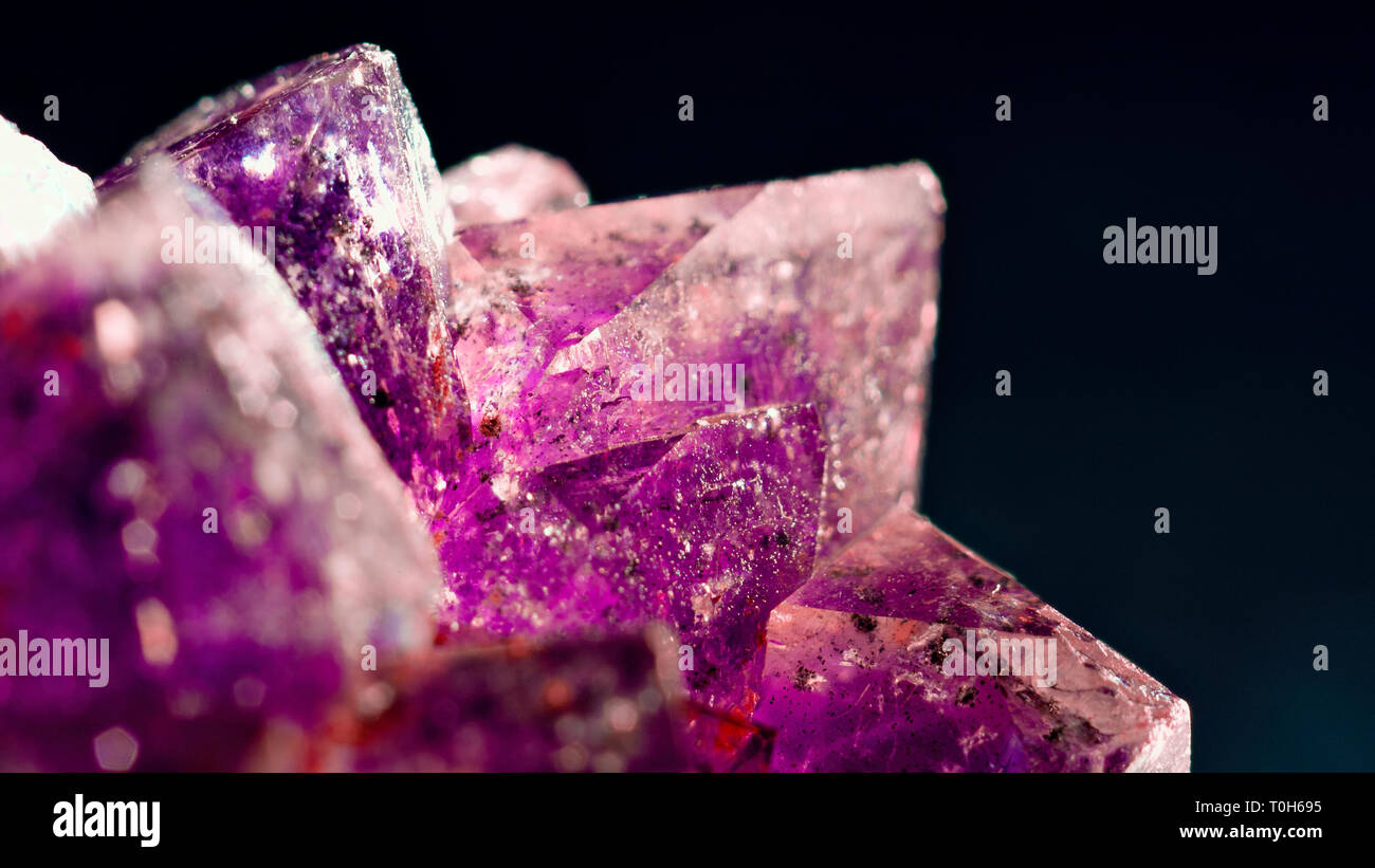 Amethyst stone against simple colour backgrounds Stock Photo - Alamy
