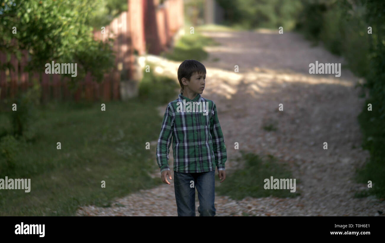Teen boy walking away hi-res stock photography and images - Alamy