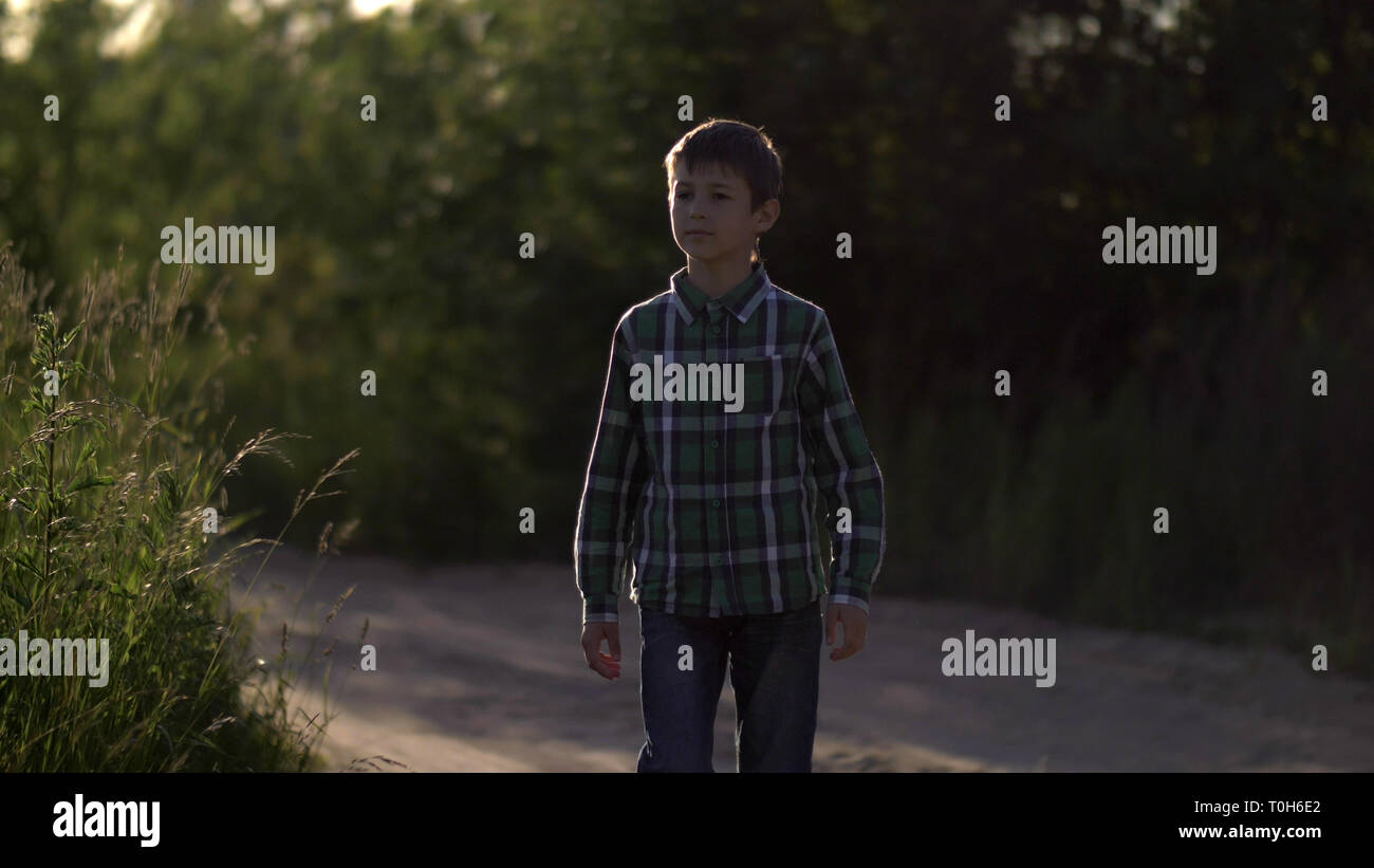 Teen boy walking away hi-res stock photography and images - Alamy
