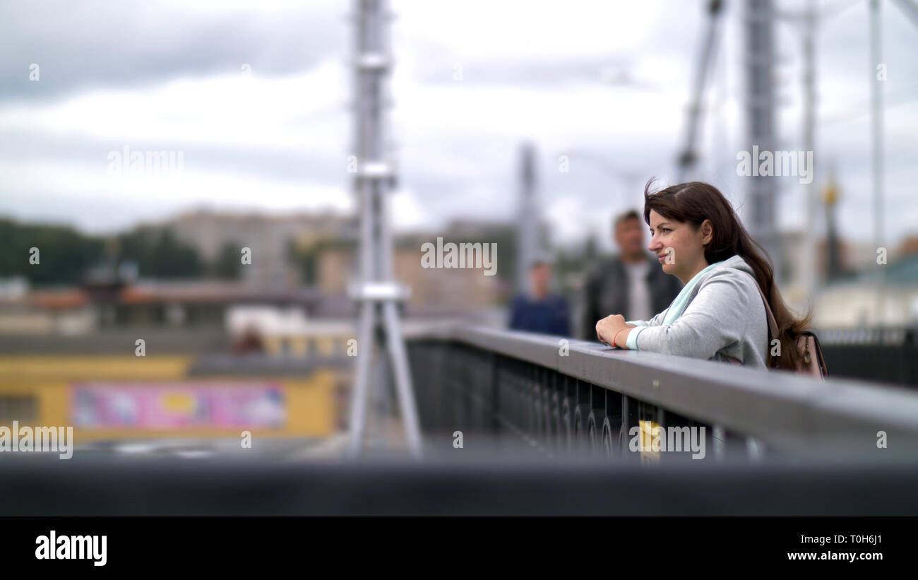 woman standing on bridge in the big city Stock Photo - Alamy