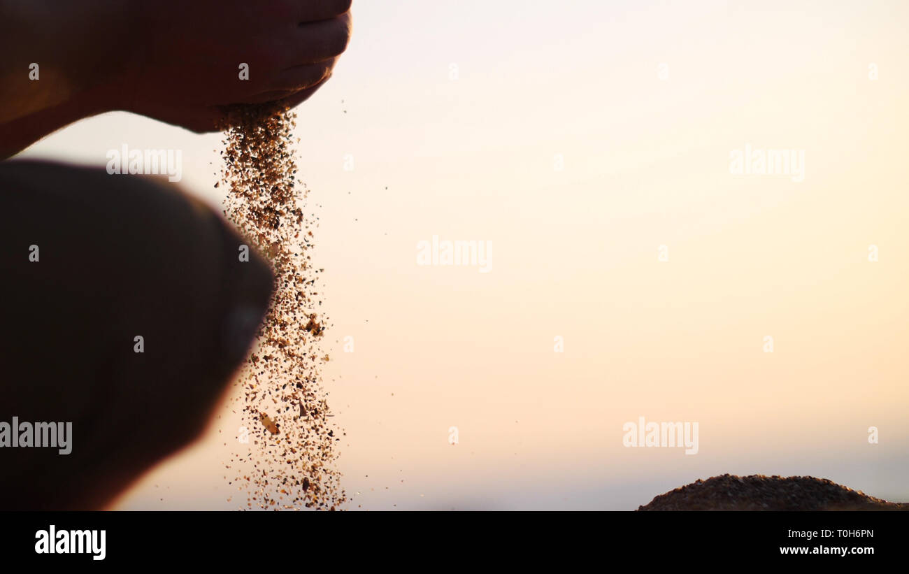 Sand falling through hands hi-res stock photography and images - Alamy