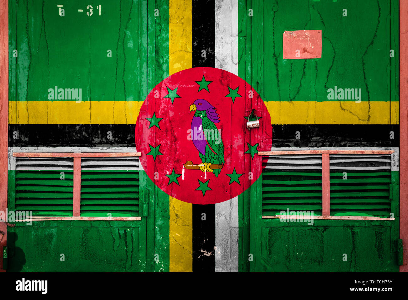 Close-up of old warehouse gate with national flag of Dominica. Concept ...